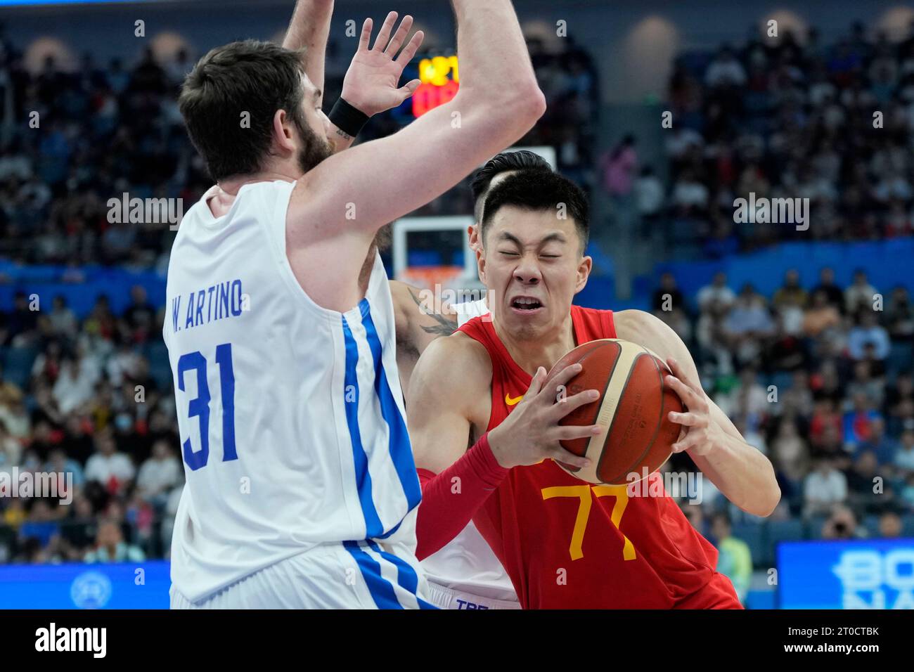 China's forward Zhang Zhenlin (77) drives against Taiwan's center William Joseph Artino (31 ...