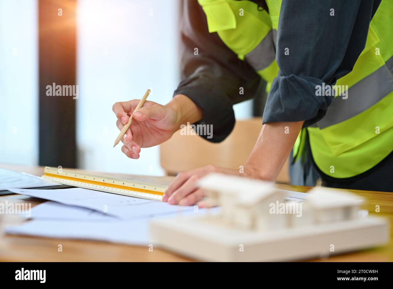 Civil engineer, architect male standing at desk with house model and ...