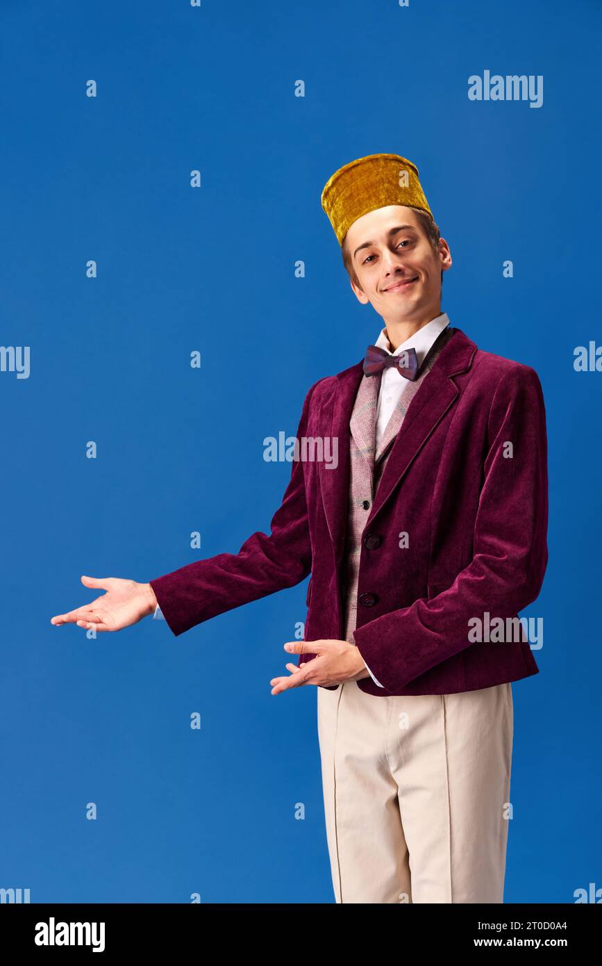 Welcome. Positive young man, porter, bell boy in costume standing ...