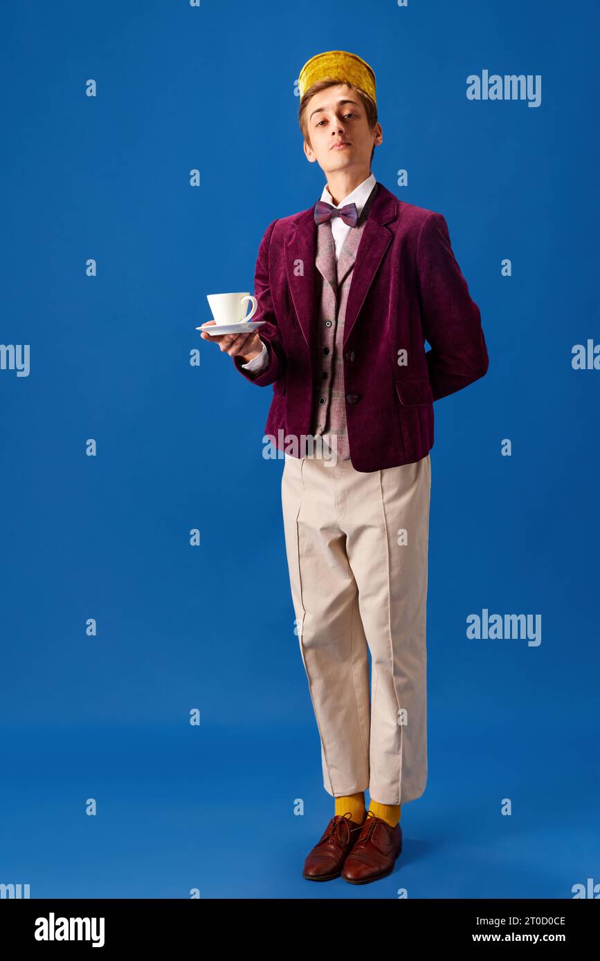 Full-length image of young guy, bell boy, hotel porter serving coffee ...