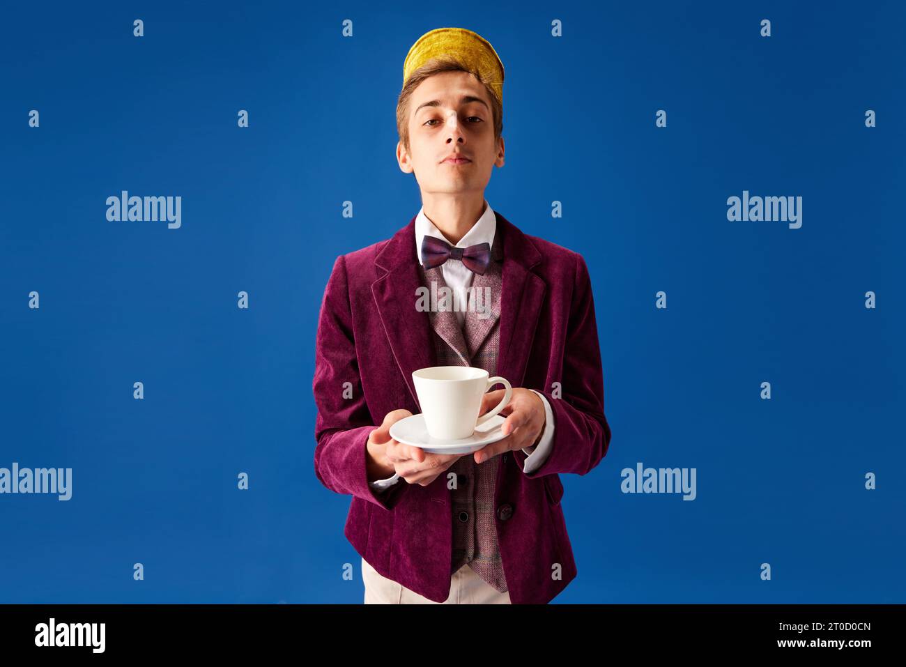 Full-length image of young guy, bell boy, hotel porter serving coffee ...
