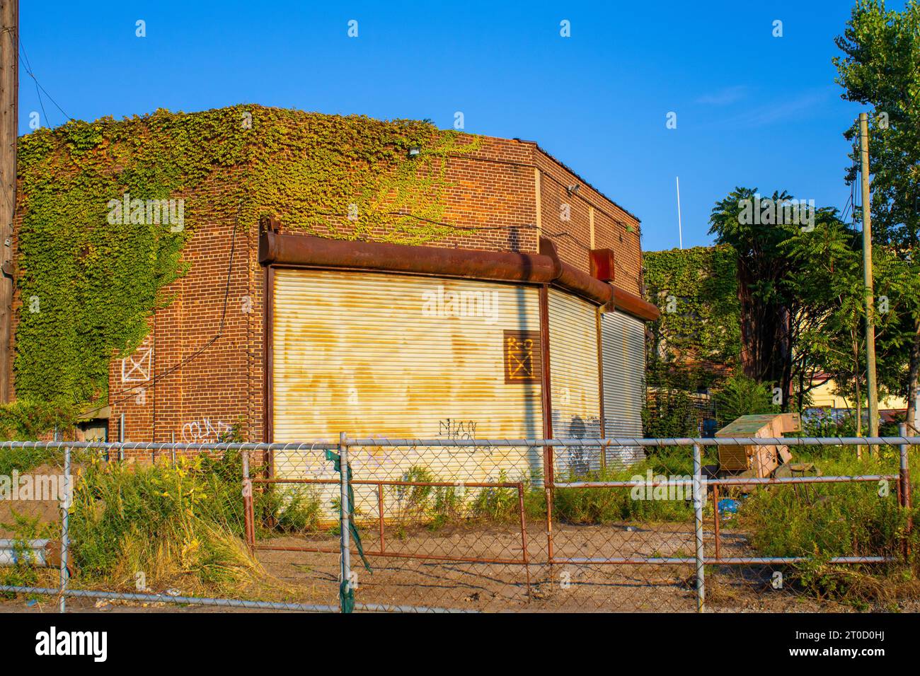 An old brick building behind a fence Stock Photo - Alamy