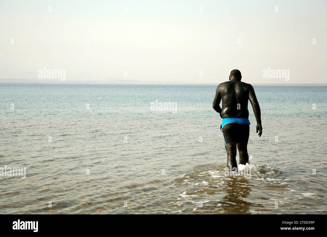 Man covered in mud at the Dead Sea Stock Photo - Alamy