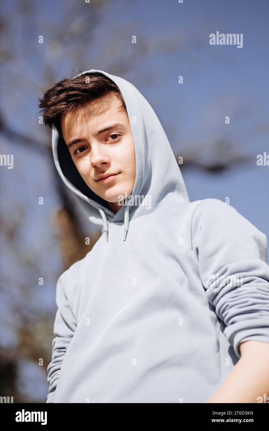 Portrait of adolescent in casual clothes at blue sky background Stock ...