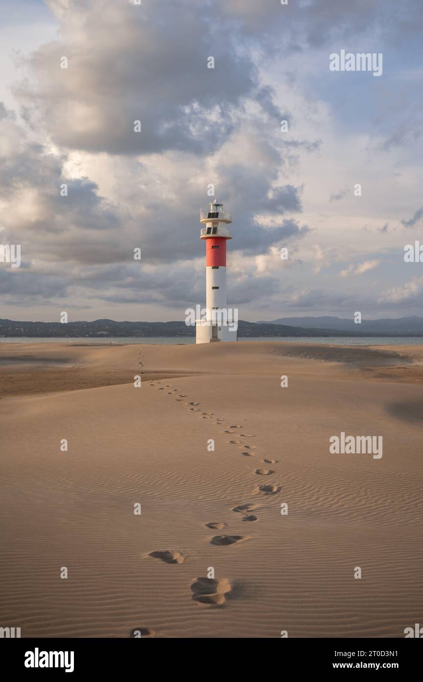 A trail of footprints leads to a lighthouse Stock Photo - Alamy