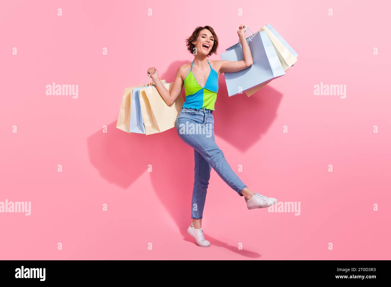 Full body length photo of energetic young girl dancing with bargain ...