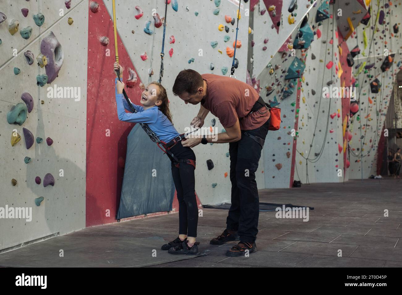 dad safety checking his daughters harness before climbing Stock Photo ...