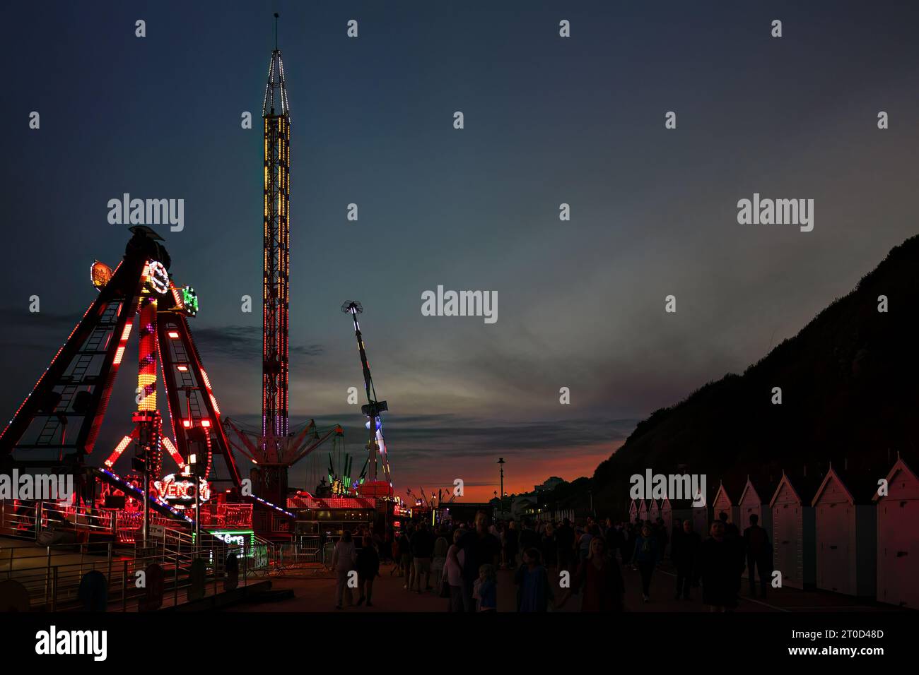 Fairground attractions at night on the beach Stock Photo - Alamy