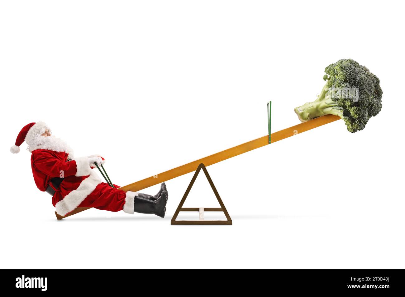 Full length shot of Santa Claus and a broccoli on a seesaw isolated on ...
