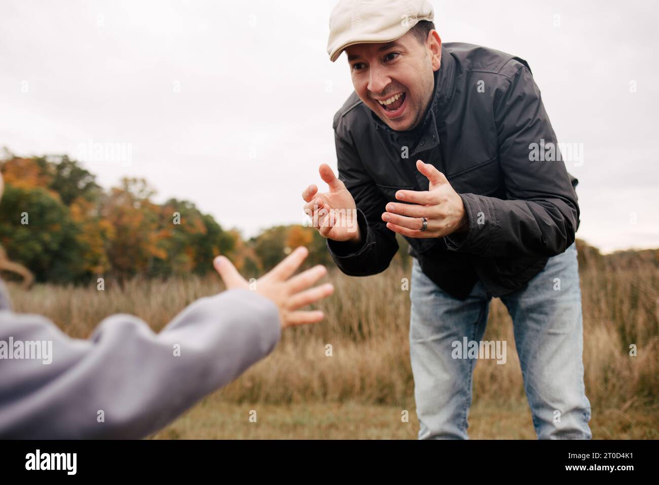 Excited father reaches out to child, pure joy reflected Stock Photo - Alamy