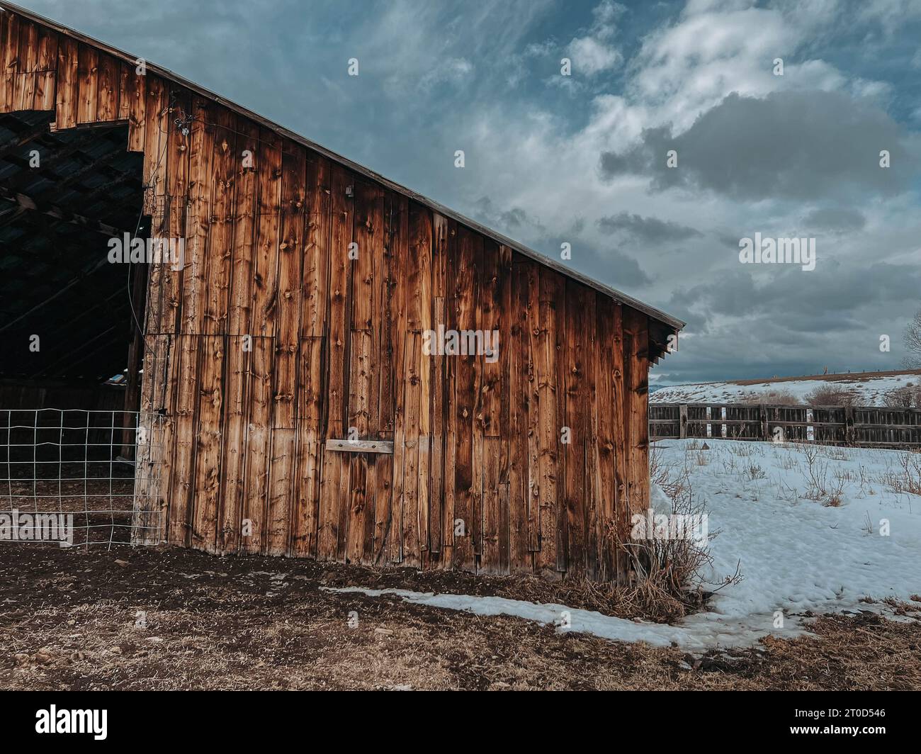 Historic rustic barn set against a snowy Montana landscape Stock Photo ...