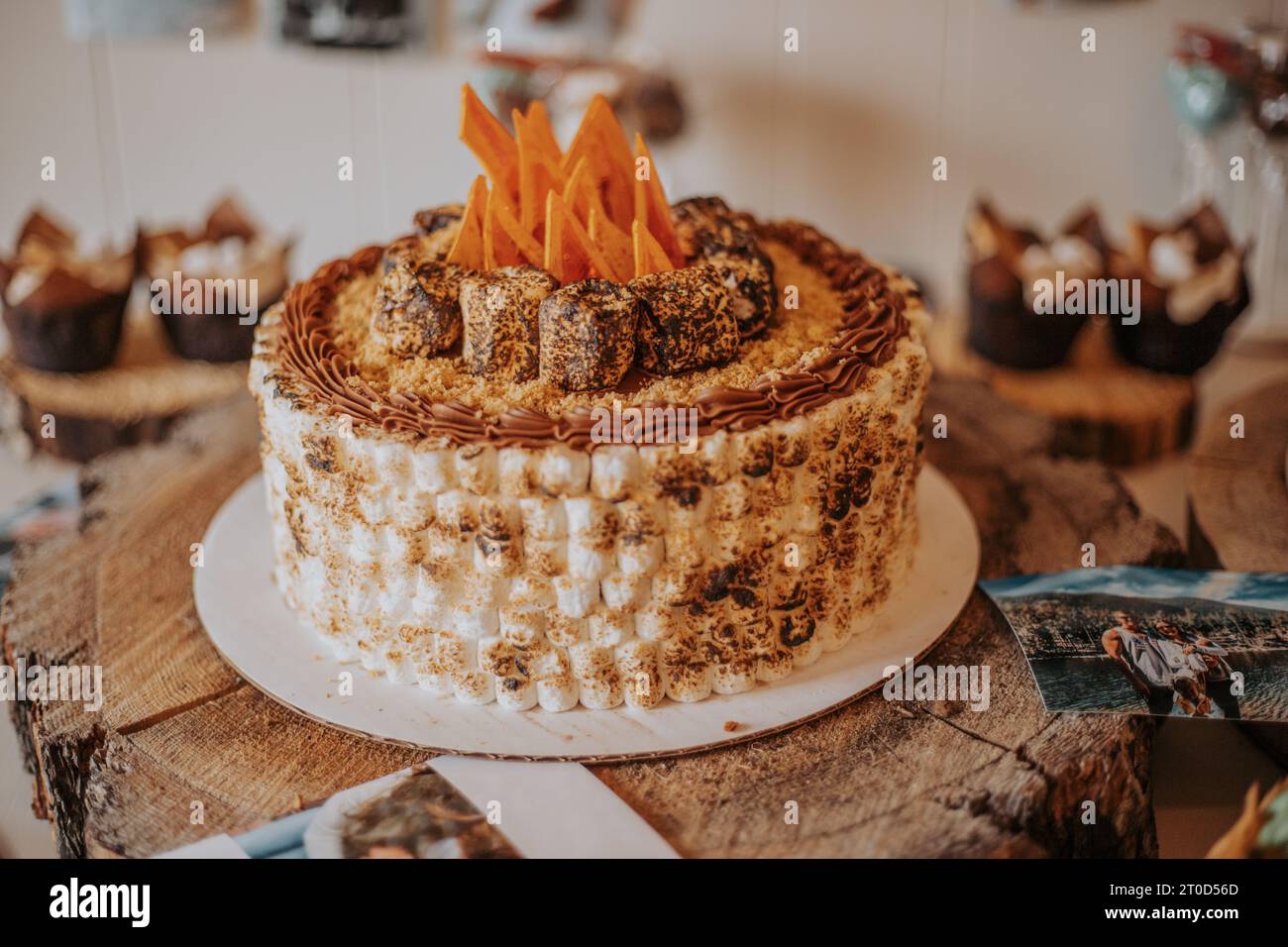 Child's campfire-decorated birthday cake desert table Stock Photo - Alamy