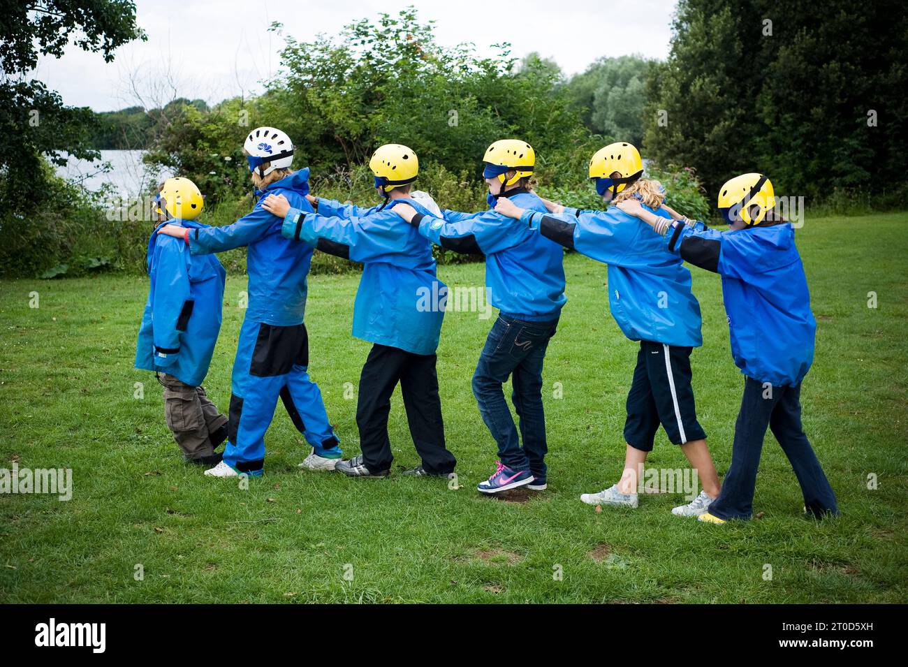 Secondary school pupils walking blindfold on an outward bound course ...