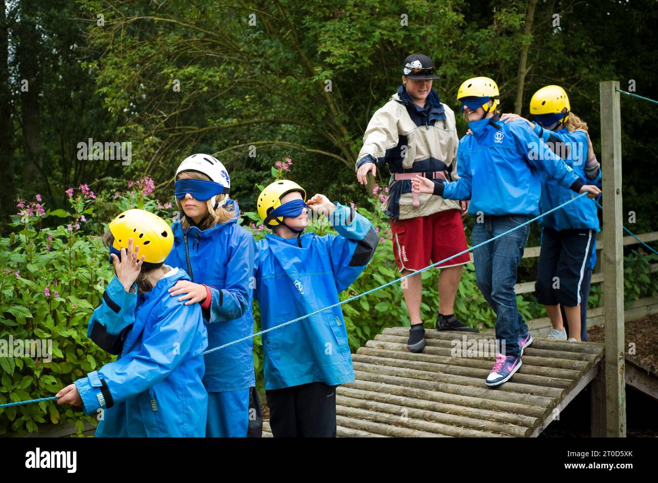 Secondary school pupils walking blindfold on an outward bound course ...