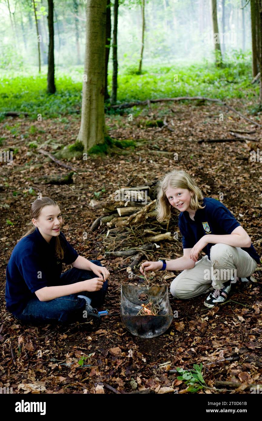 Secondary school pupils on outward bound course lighting a fire Stock ...