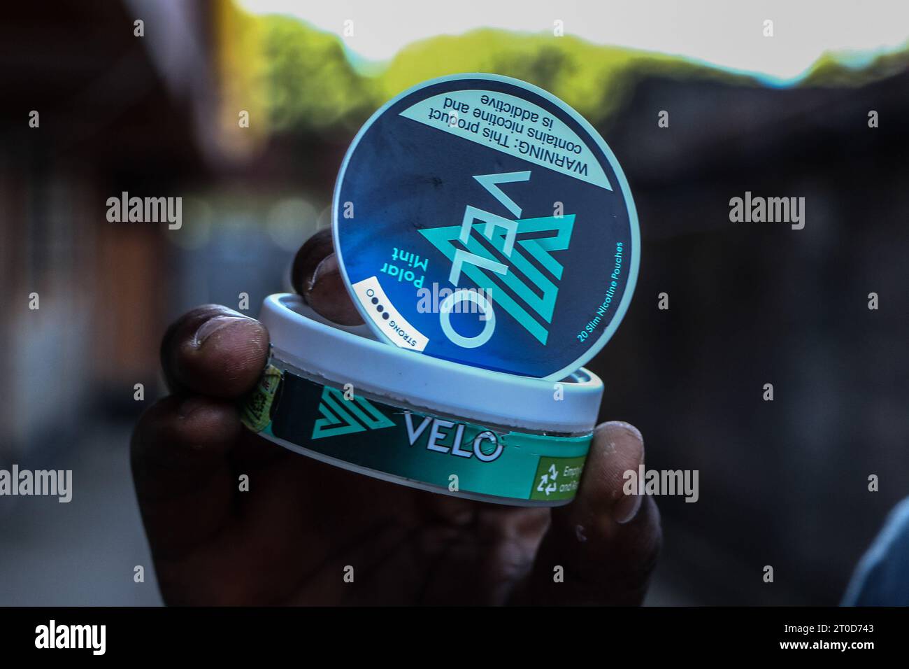 Nakuru, Kenya. 06th Oct, 2023. A hand holds a plastic container from ...