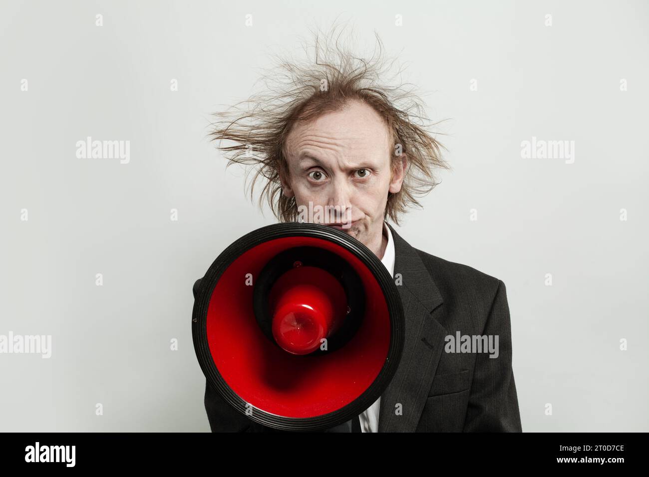 Stressed businessman with red loudspeaker on white background Stock ...