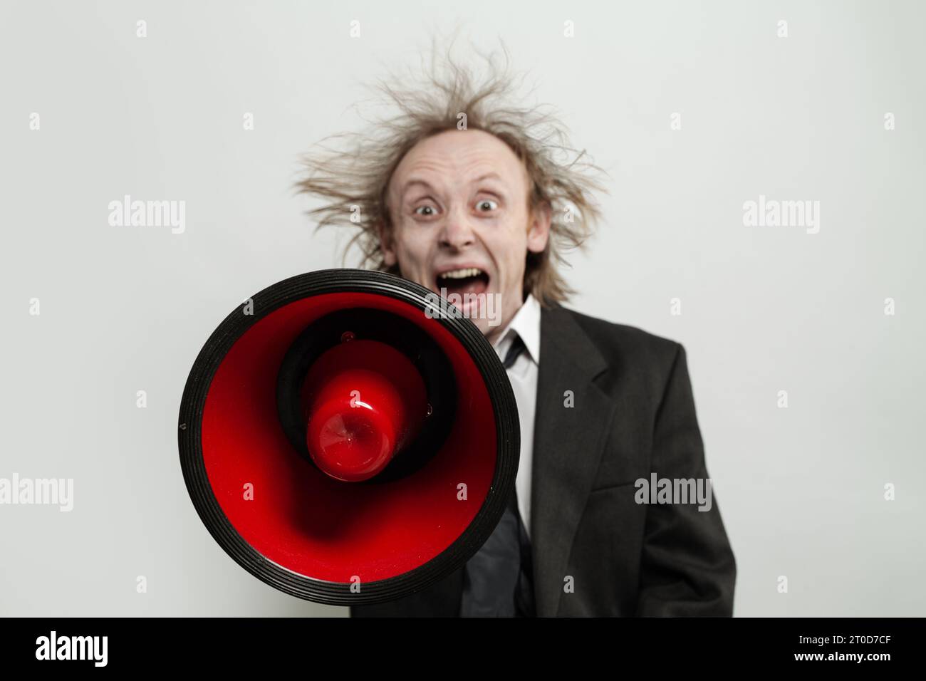 Megaphone loudspeaker in hand of funny mad businessman on white ...