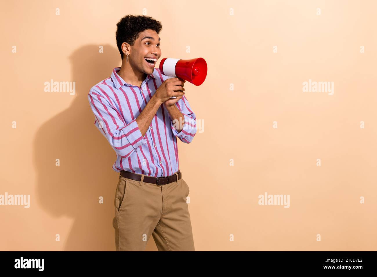 Photo of funny ecstatic man with afro hair dressed striped shirt look ...