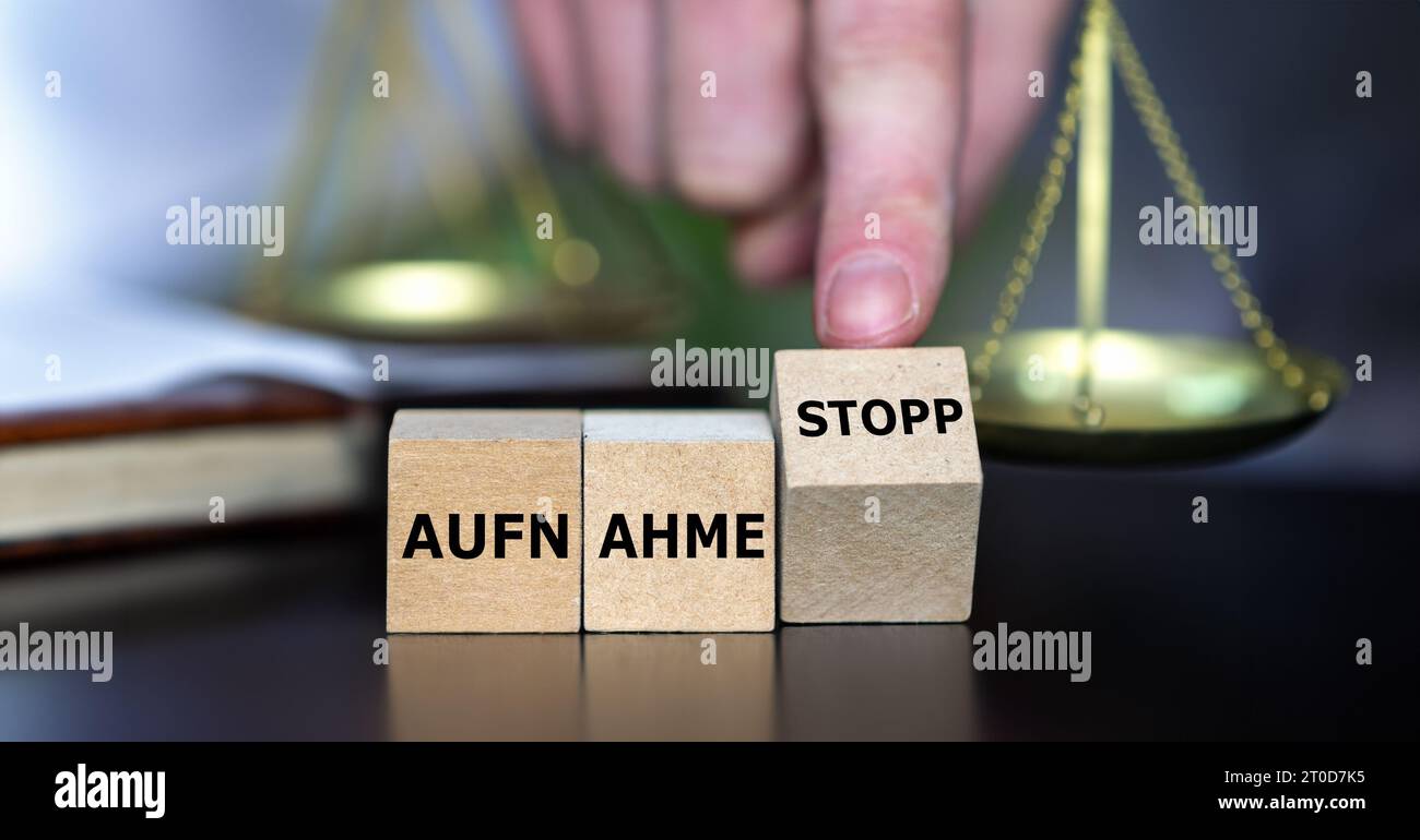Wooden cubes form the German expression 'Aufnahme stopp' (migration ...