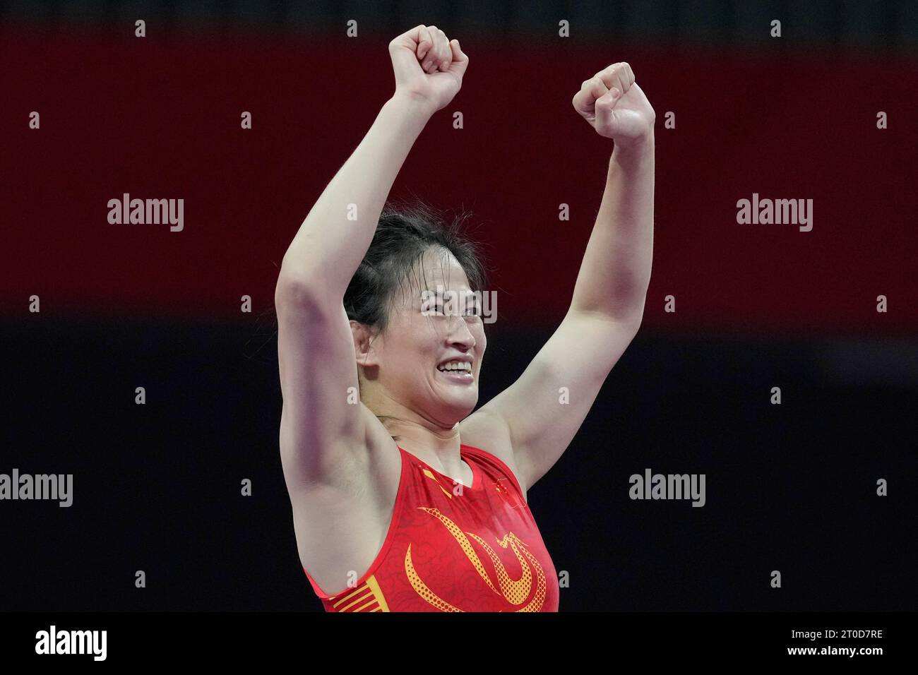 China's Zhou Feng celebrates her win over Kyrgyztan's Nurzal Nurtaeva ...