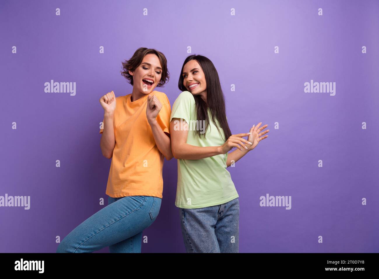 Photo of excited funky girls dressed t-shirts dancing having fun ...
