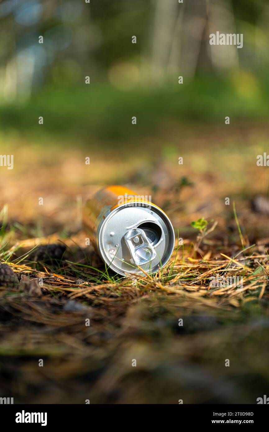 empty aluminum drinking canister tossed on a ground Stock Photo - Alamy