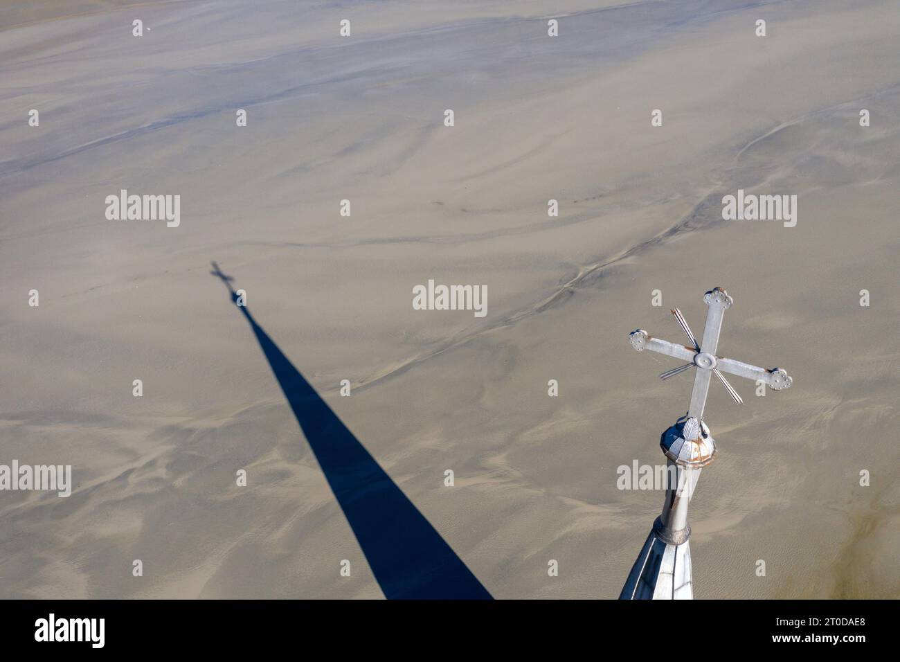 Aerial view of a church tower with cross, buried under mud and mining ...