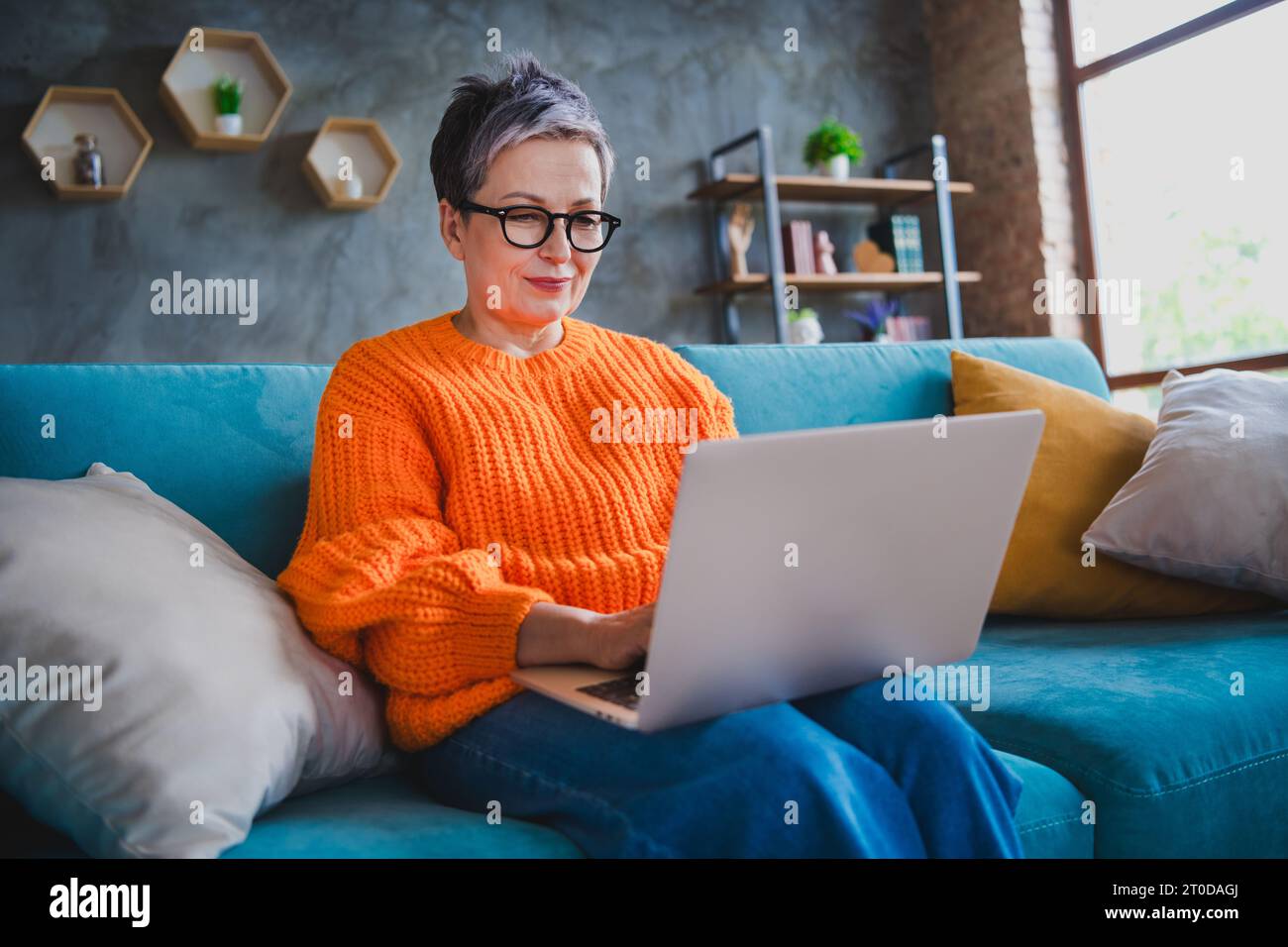 Photo of happy smiling elderly lady wear orange pullover communicating ...