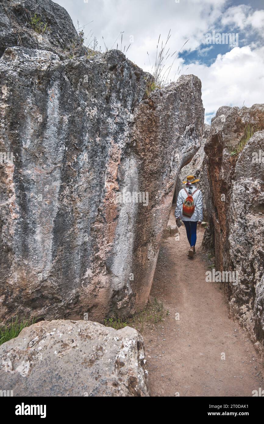 Tourist exploring at Archaelogical Qenqo. Strange and weird rock ...