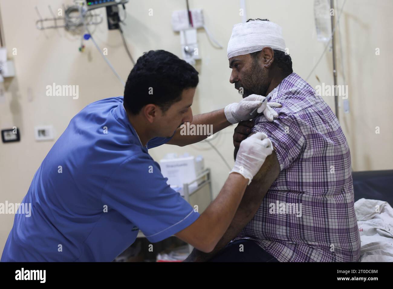 A man injured in the shelling from the Syrian government positions gets ...