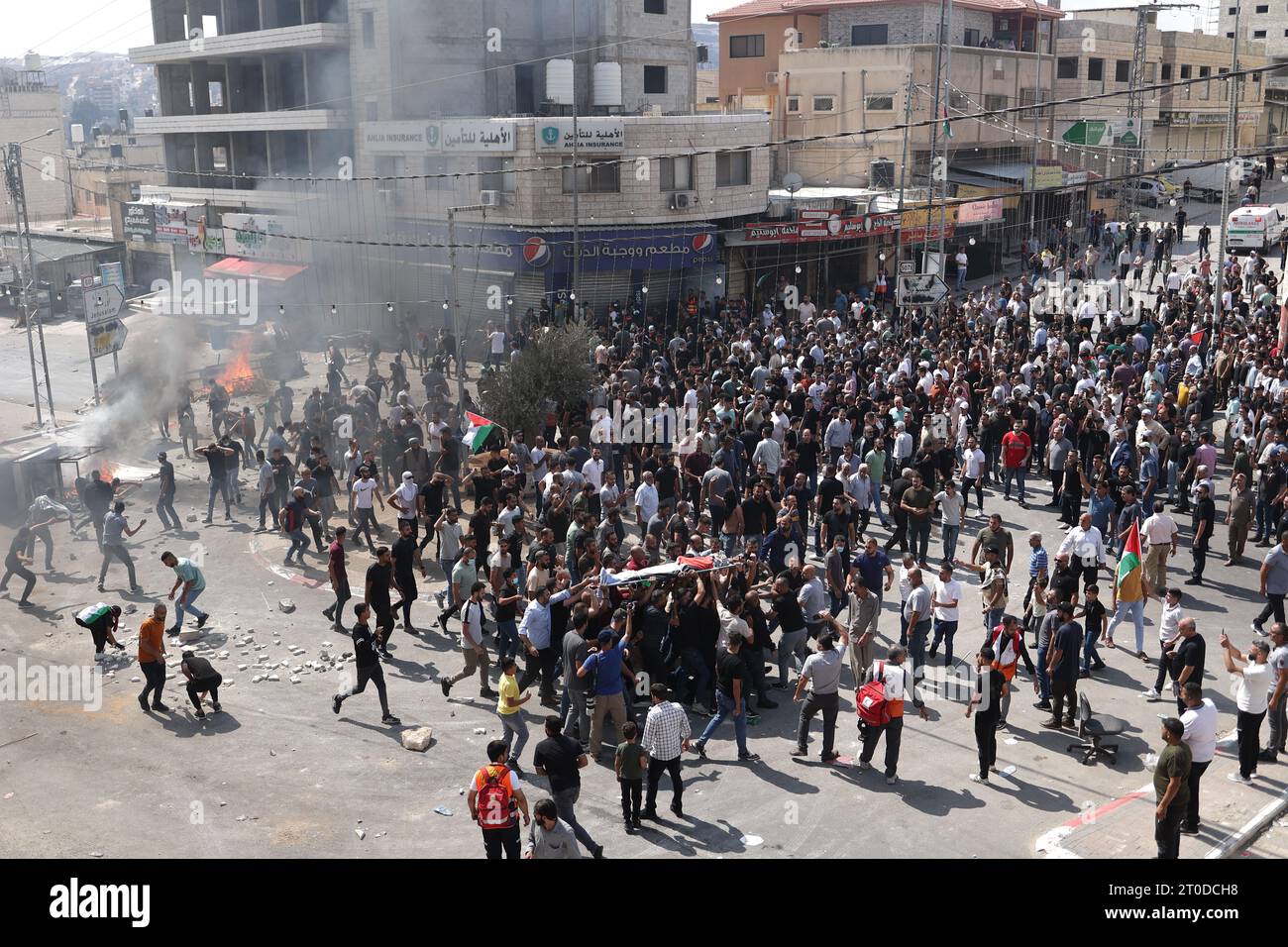 Huwara, Palestinian Territories. 06th Oct, 2023. Palestinians carry the ...