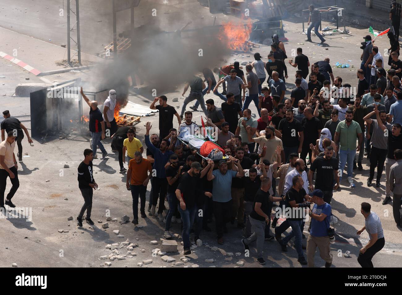 Huwara, Palestinian Territories. 06th Oct, 2023. Palestinians carry the ...