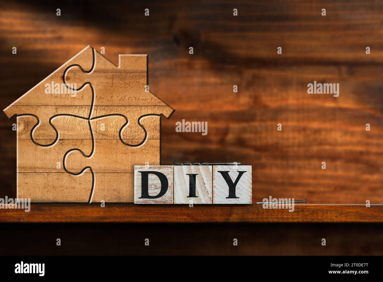 Wooden house made of puzzle pieces and text Diy (Do It Yourself), made ...