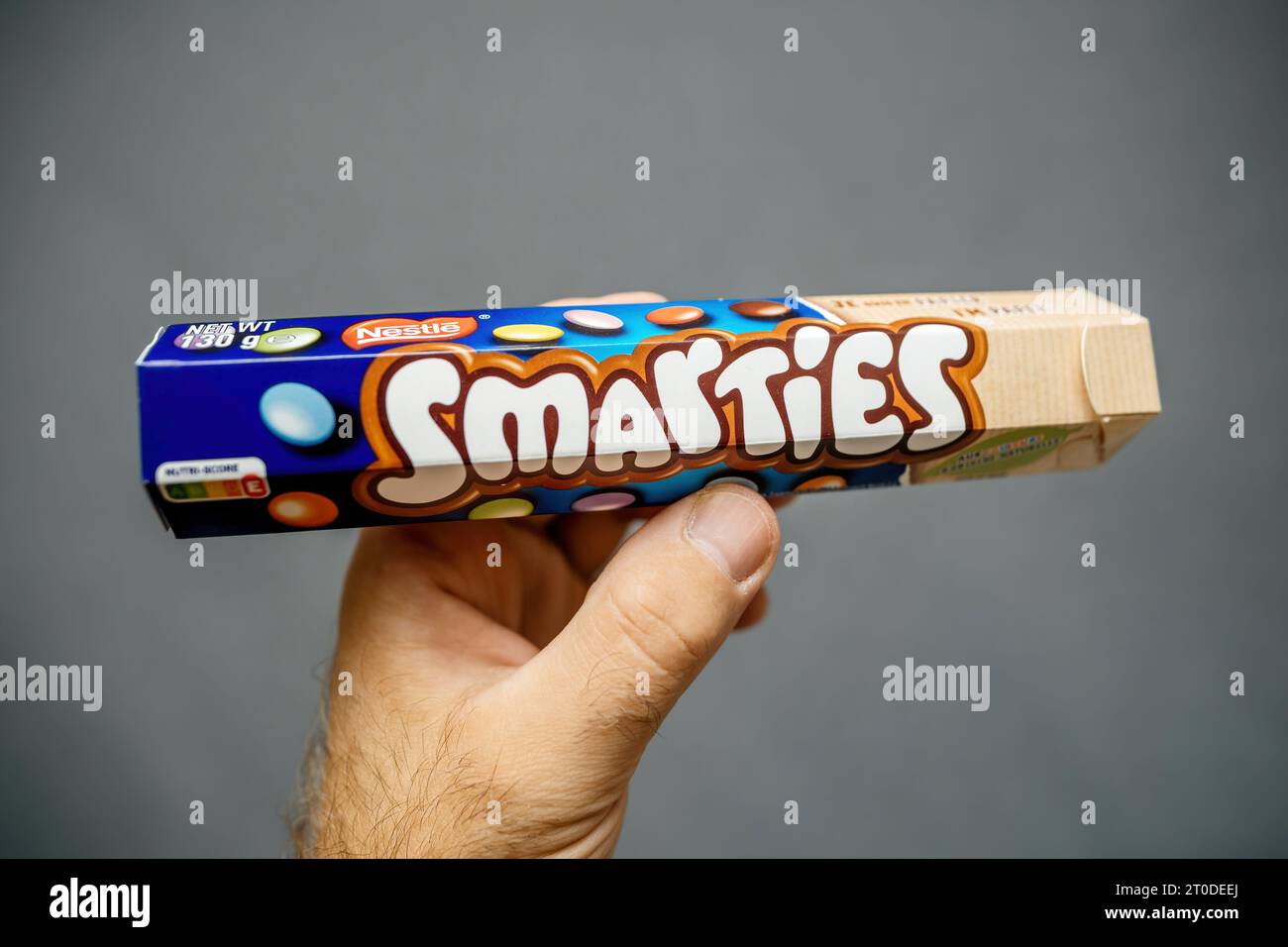 Paris, France - Jul 12, 2023: holds a package of Smarties, setting off ...