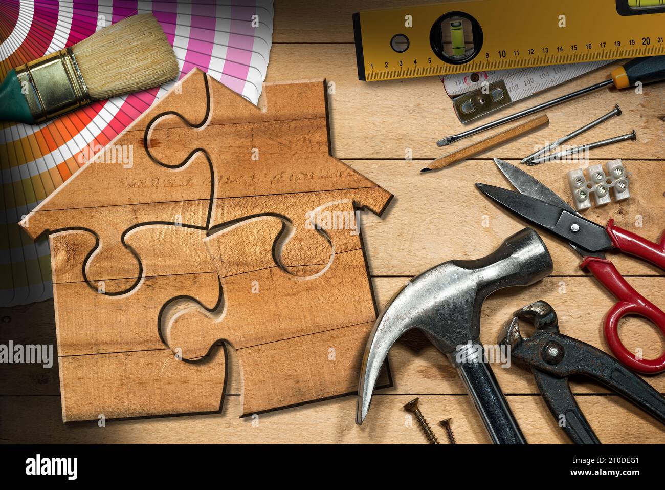 Home improvement concept. Wooden house made of puzzle pieces on a ...