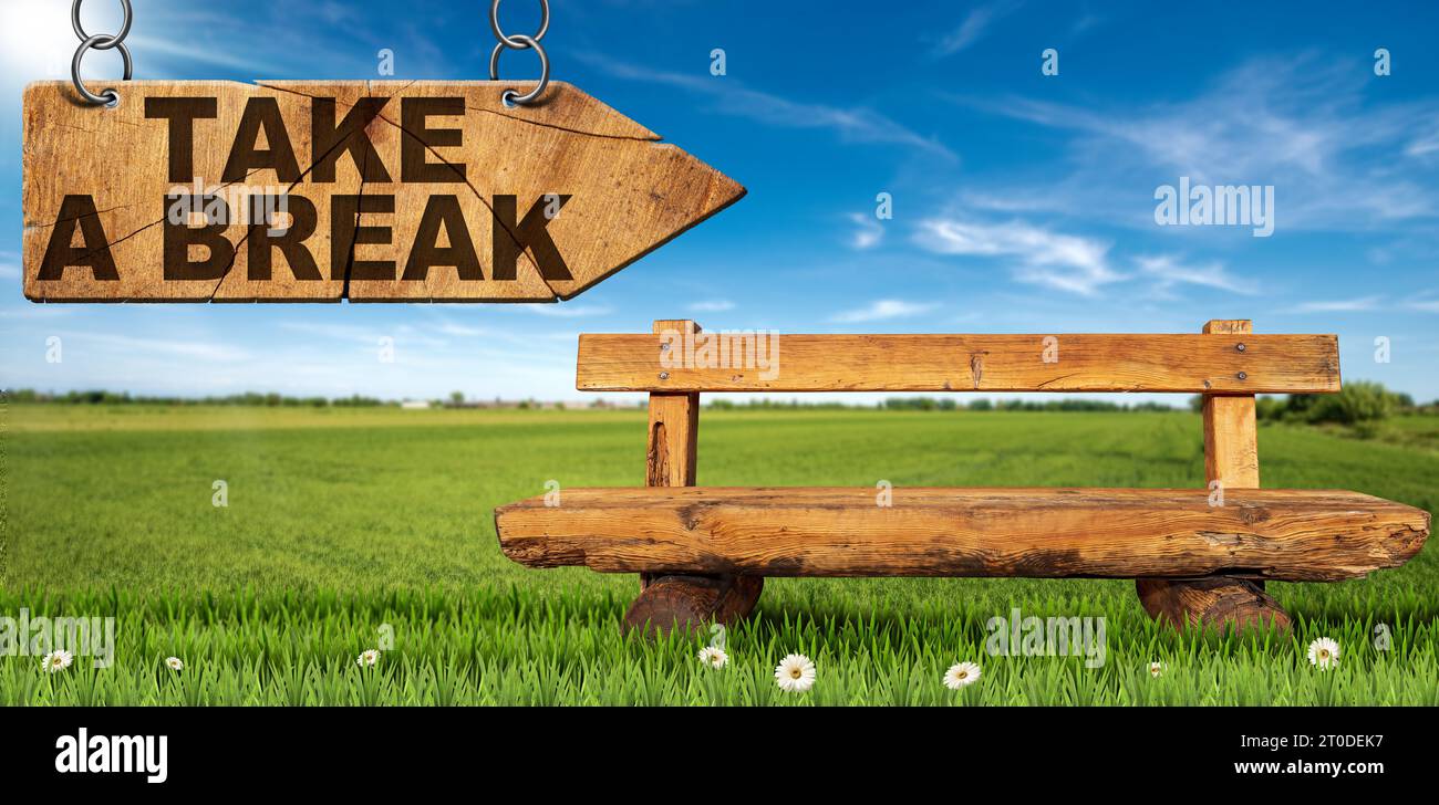 Wooden directional sign with text Take a Break on a countryside ...