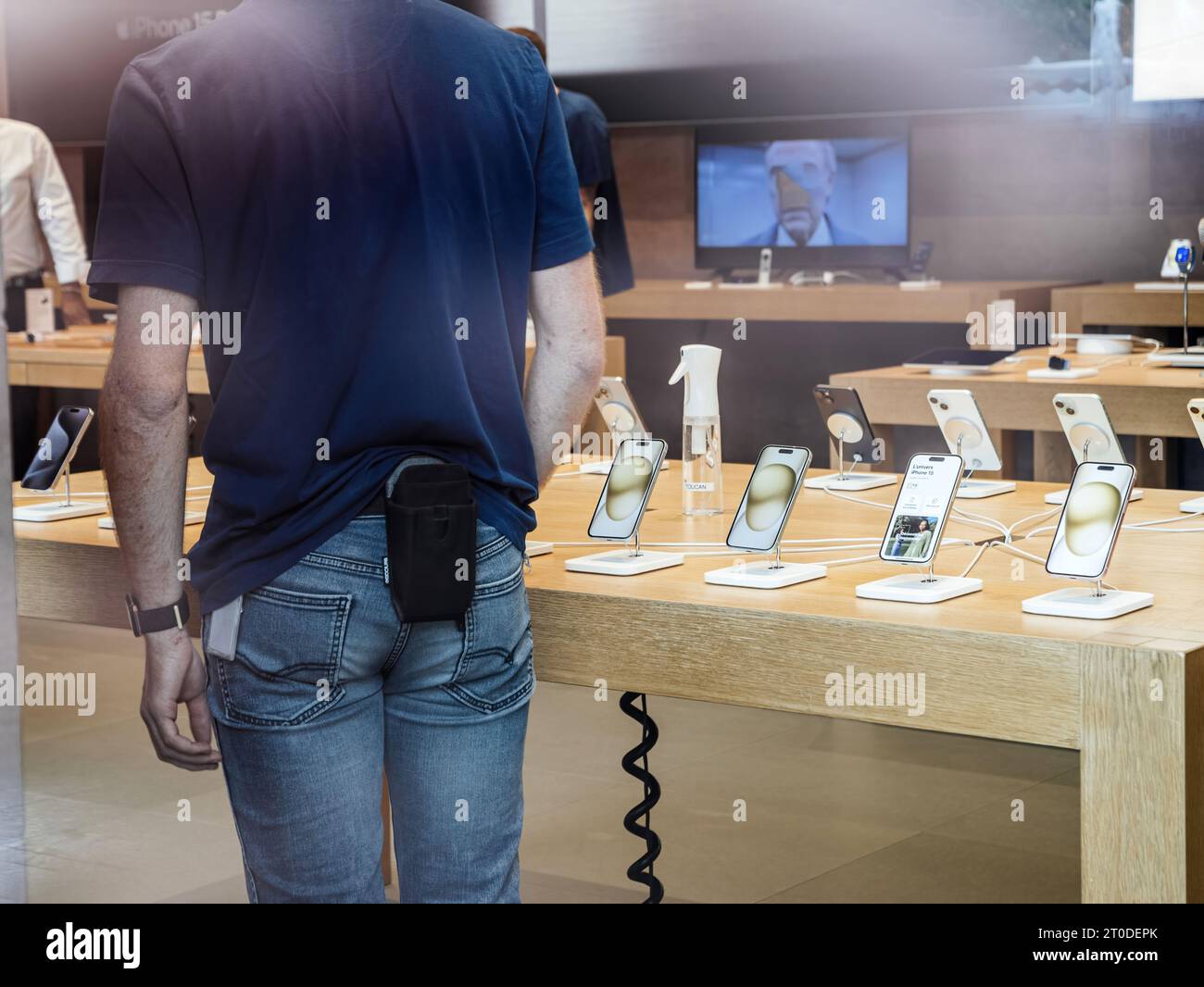 Paris, France - Sep 22, 2023: Observing the rear view of an Apple Genius worker in proximity to ...