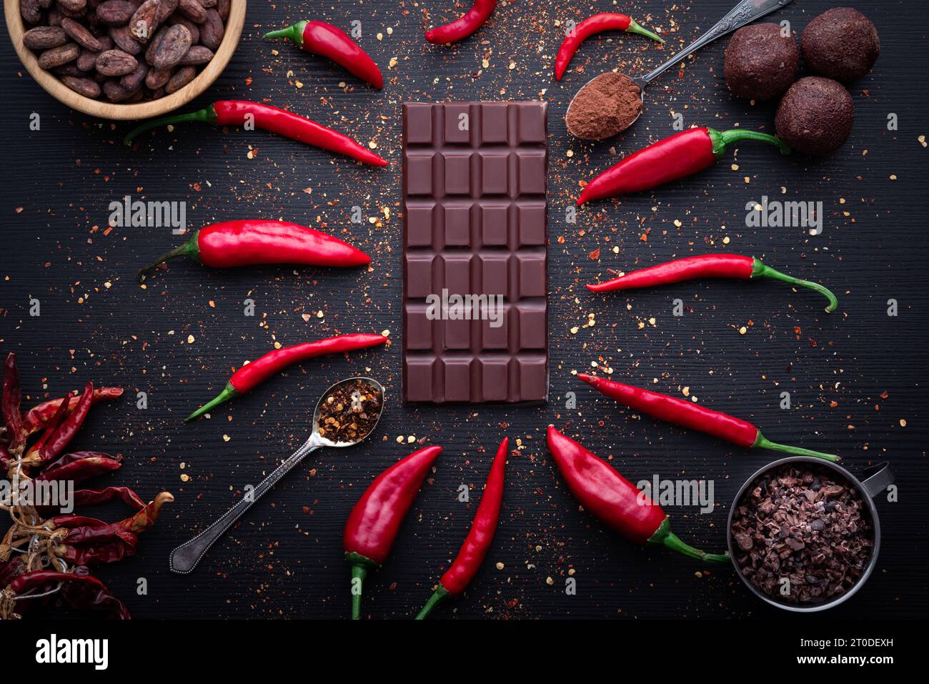 Dark chocolate bar, red hot chilli pepper cayenne, dry hot chili spices, cocoa beans nibs powder ...