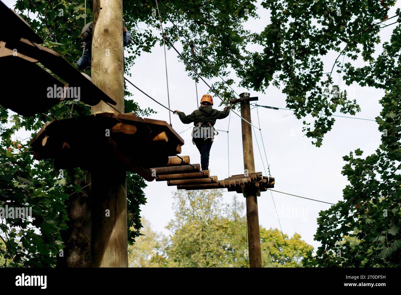 well equipped teenage boy in outdoor passing obstacle course. Active ...
