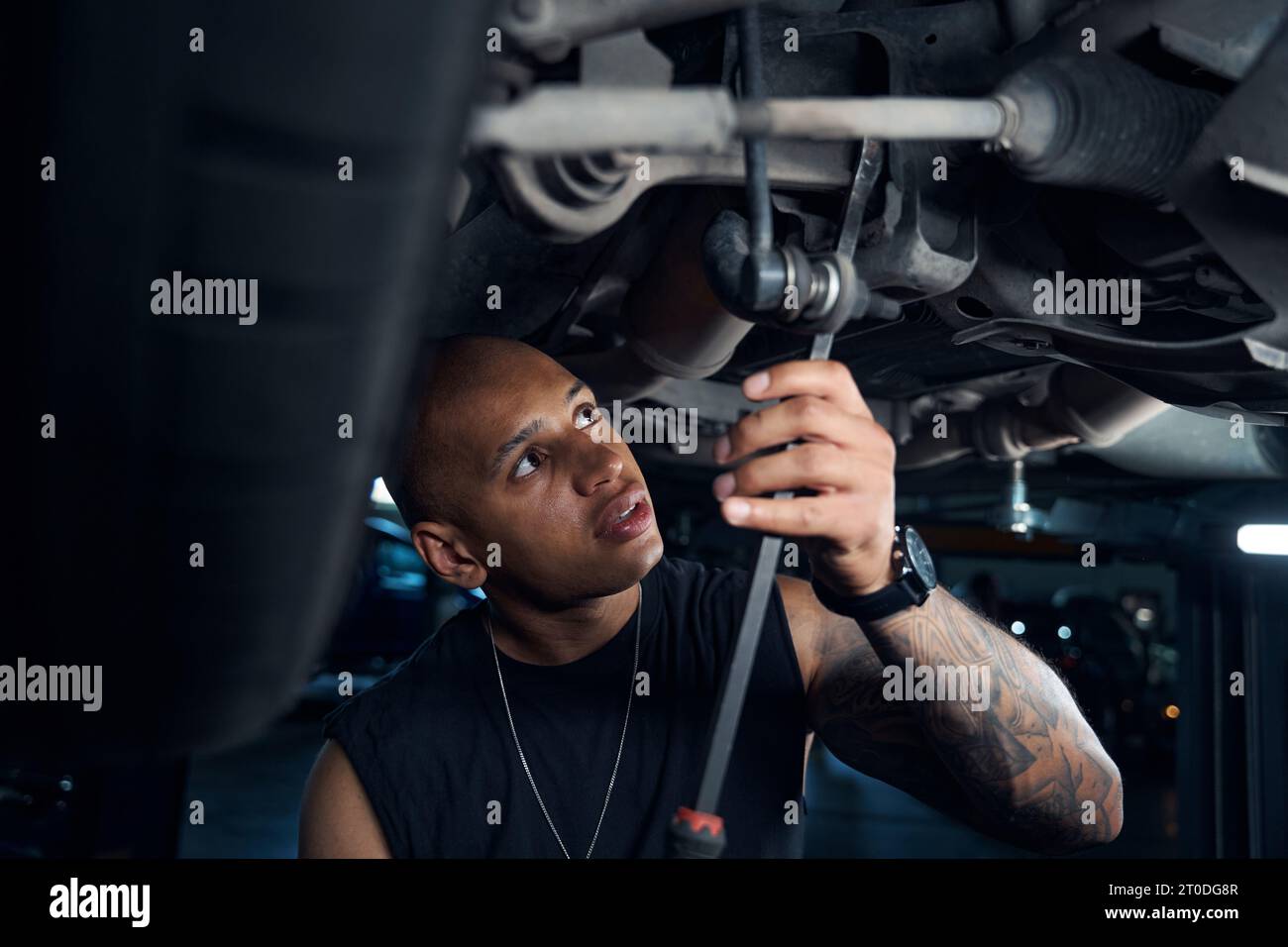 African American mechanic checking and repairing car axle Stock Photo ...