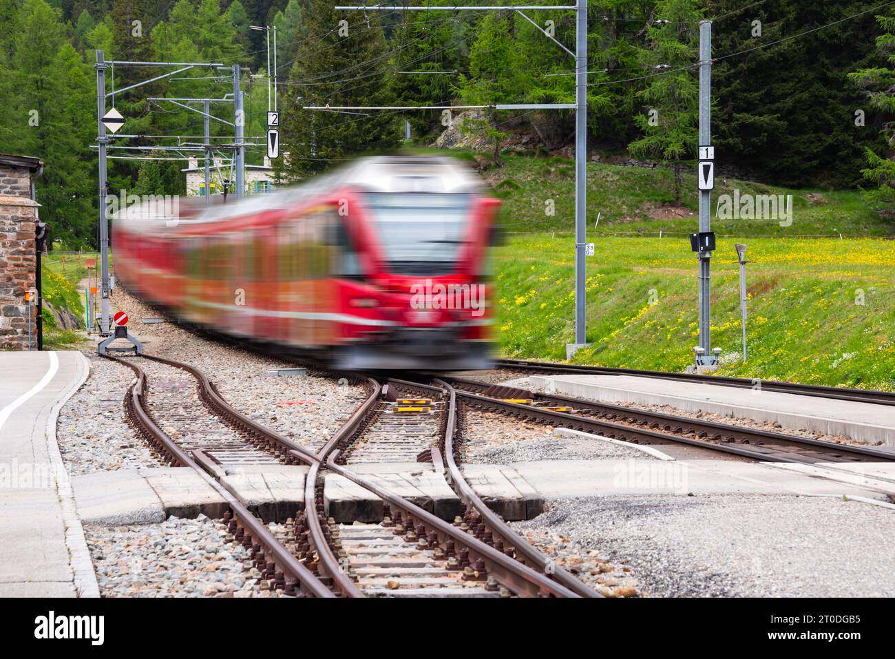 Red Swiss express train arriving to station with many tracks Stock ...