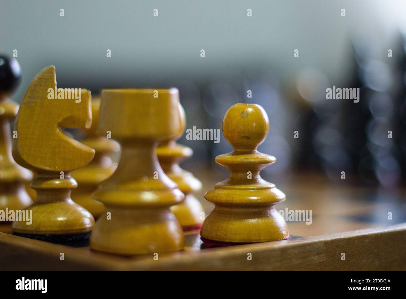A yellow chessboard and its pieces evoke the timelessness of a classic ...