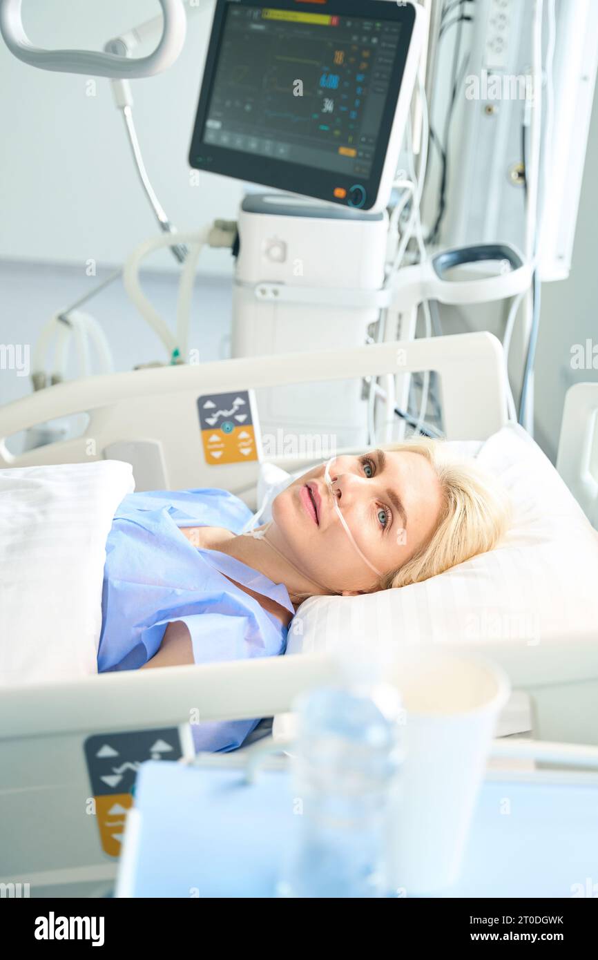 Recovering woman after surgery lies in ward with modern equipment Stock ...
