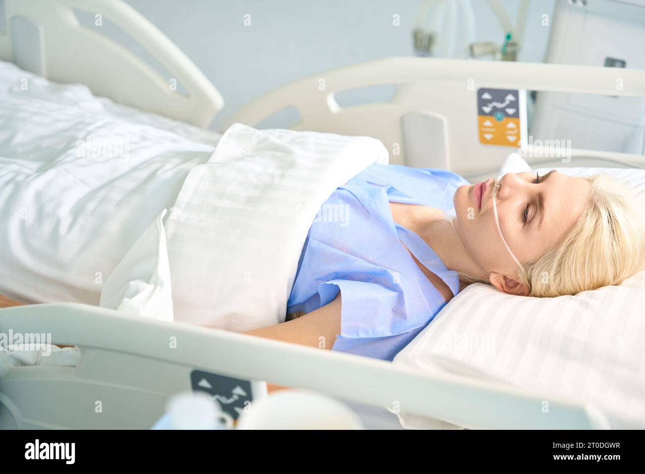 Blonde woman after surgery lies in room with modern equipment Stock ...