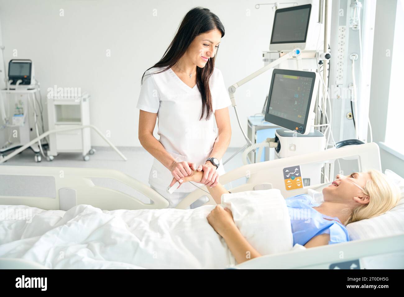 Physician attending to a woman in bed hi-res stock photography and ...