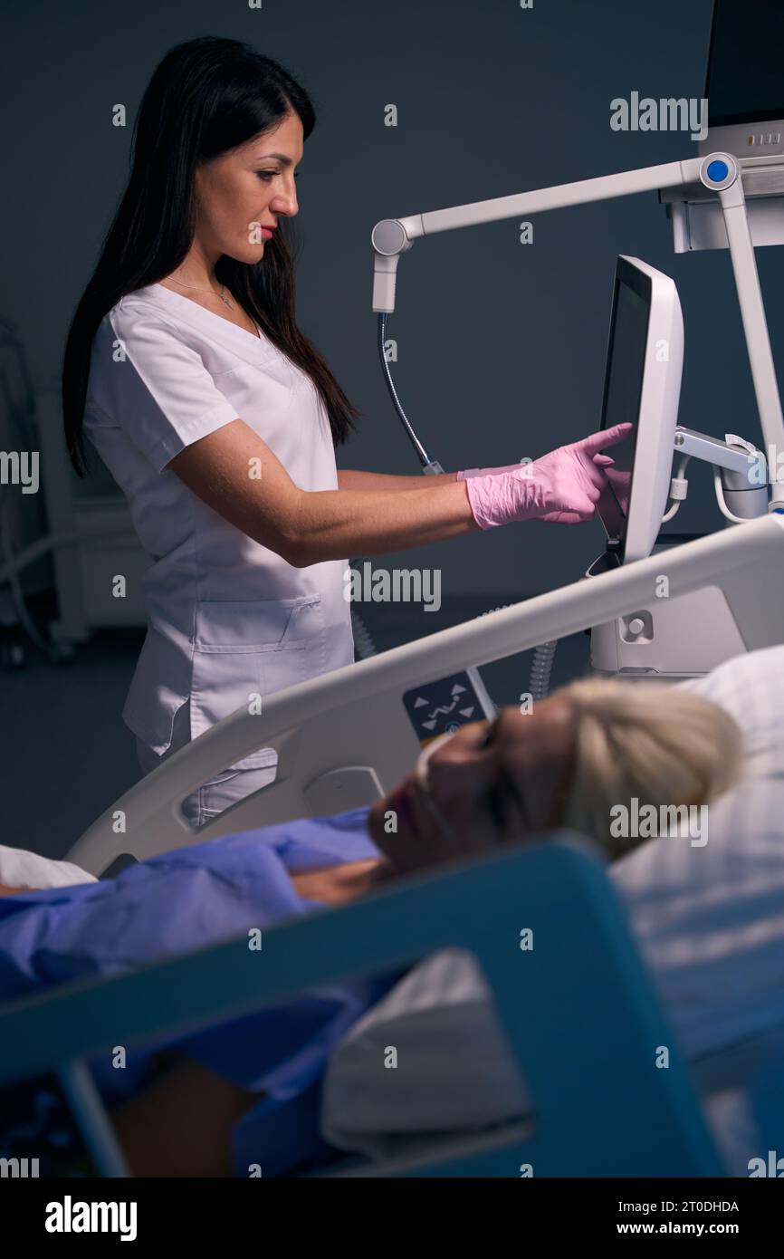 Pretty female doctor uses modern equipment in the recovery room Stock ...