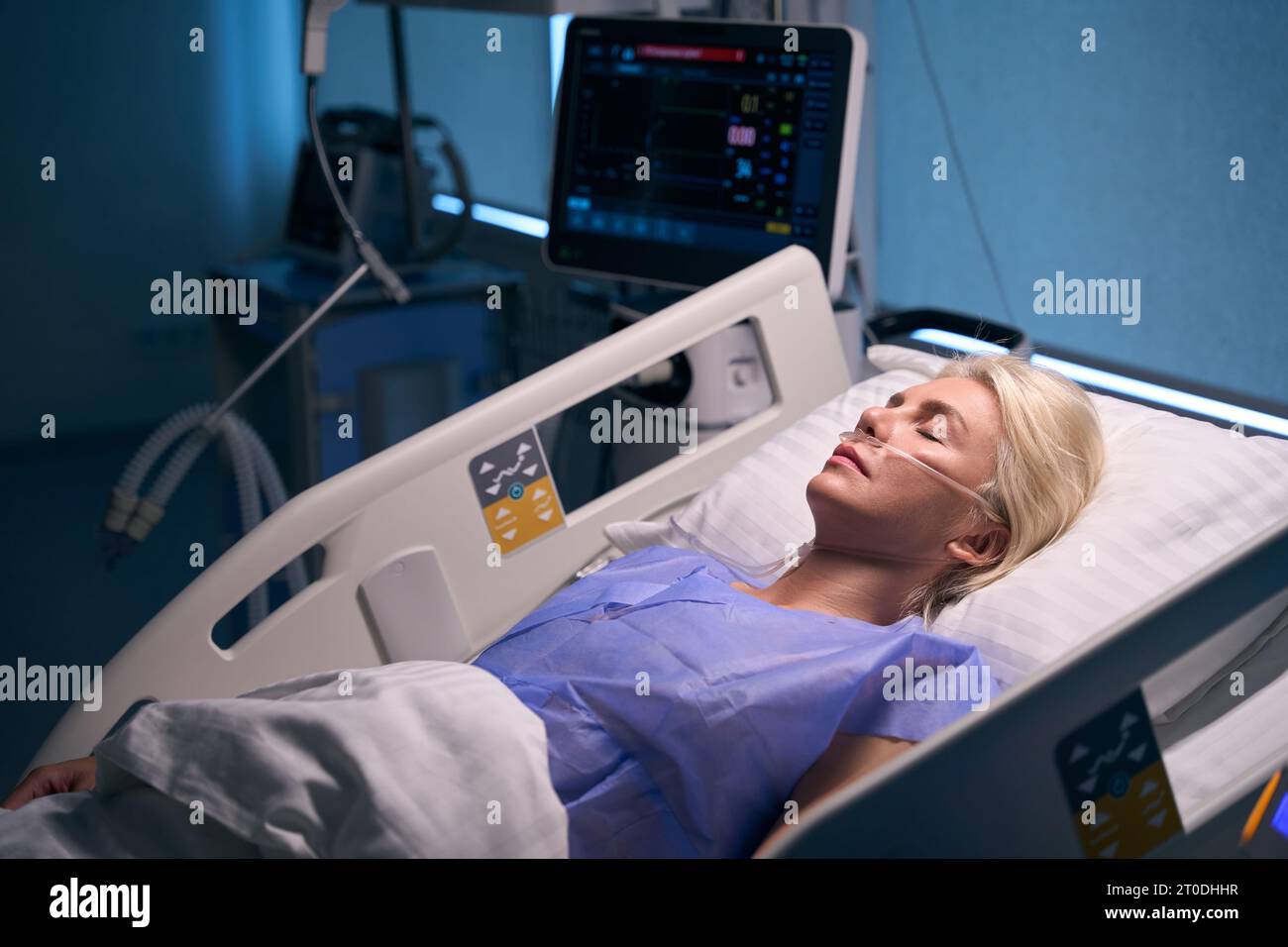 Beautiful Woman Lies On Postoperative Bed In Intensive Care Unit Stock