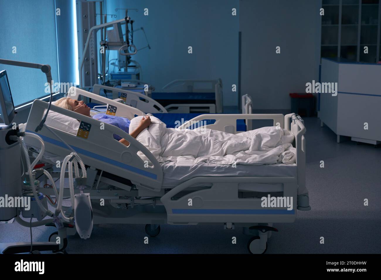 Recovering Woman Lies On Postoperative Bed In Intensive Care Unit Stock