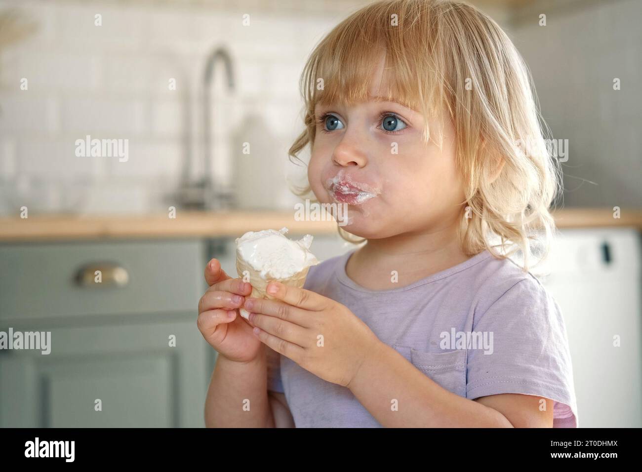 Baby girl enjoying ice cream. Pretty little toddler eating an ice-cream ...